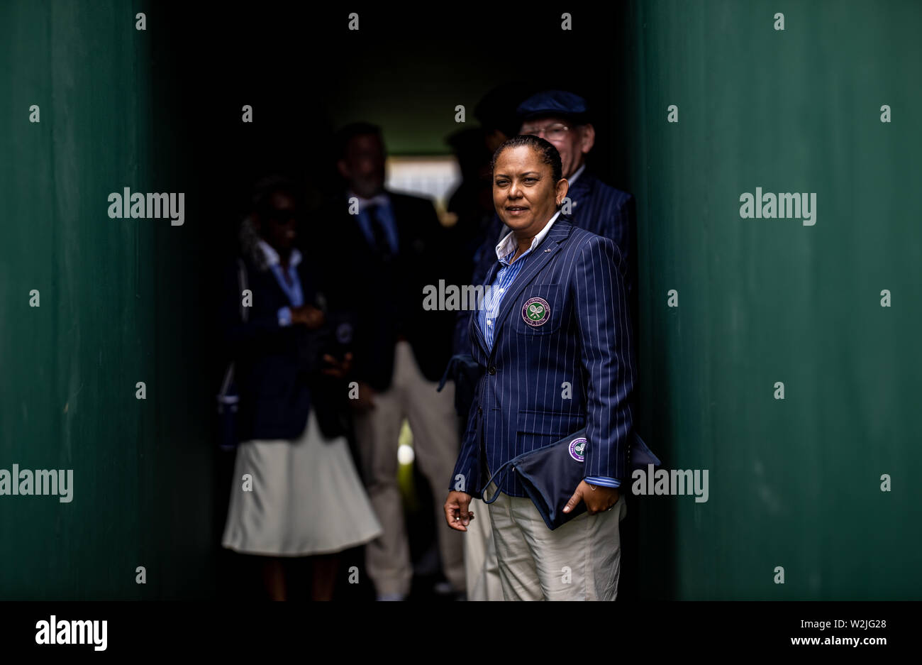 Line judges wait court side on day eight of the Wimbledon Championships ...