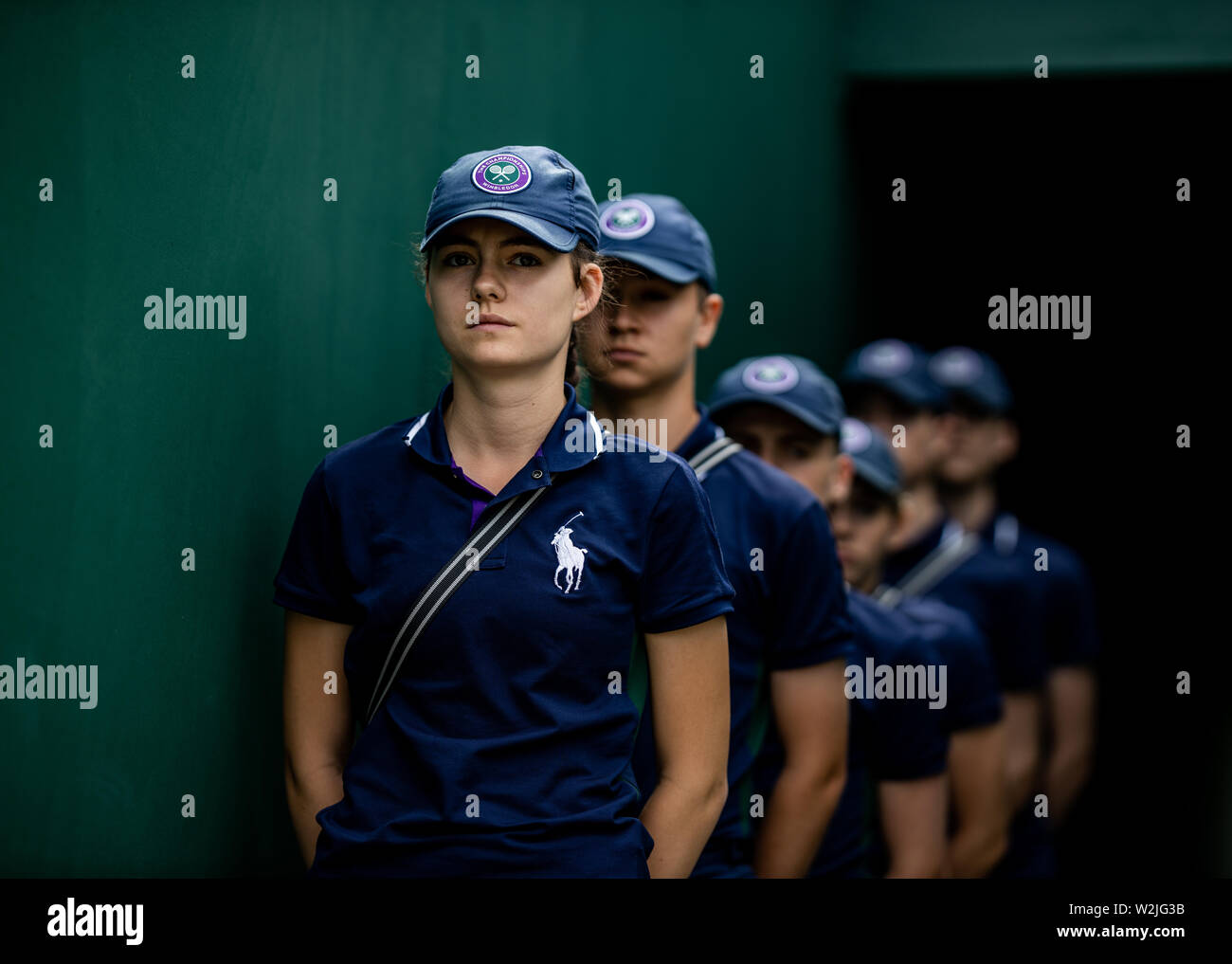 Ball boys and girls wait court side on day eight of the Wimbledon ...