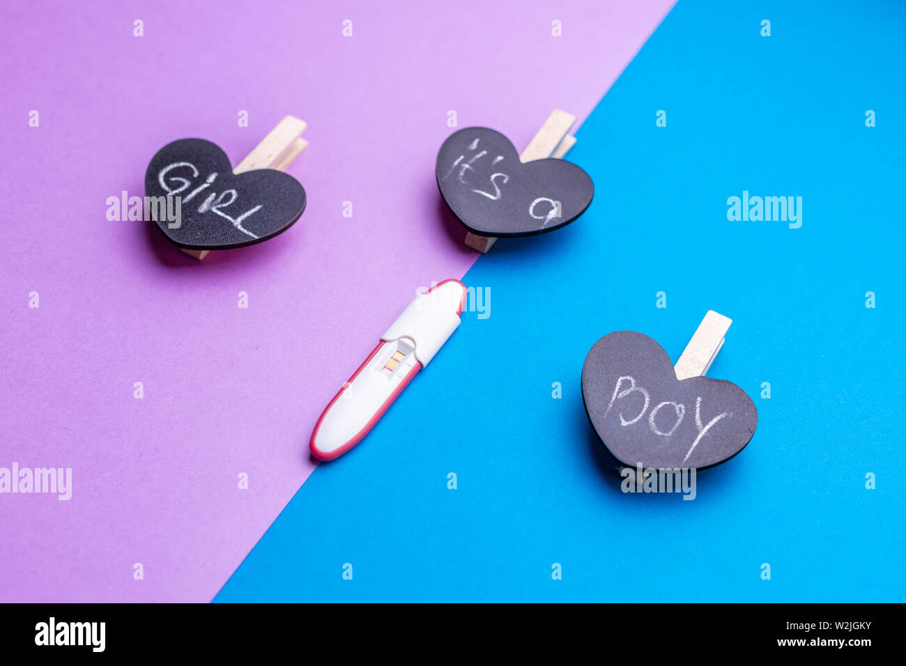 Its a Boy or girl concept. Pregnancy test over pink and blue background ...