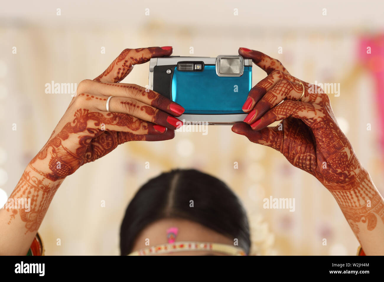 Indian bride taking picture with a digital camera Stock Photo - Alamy