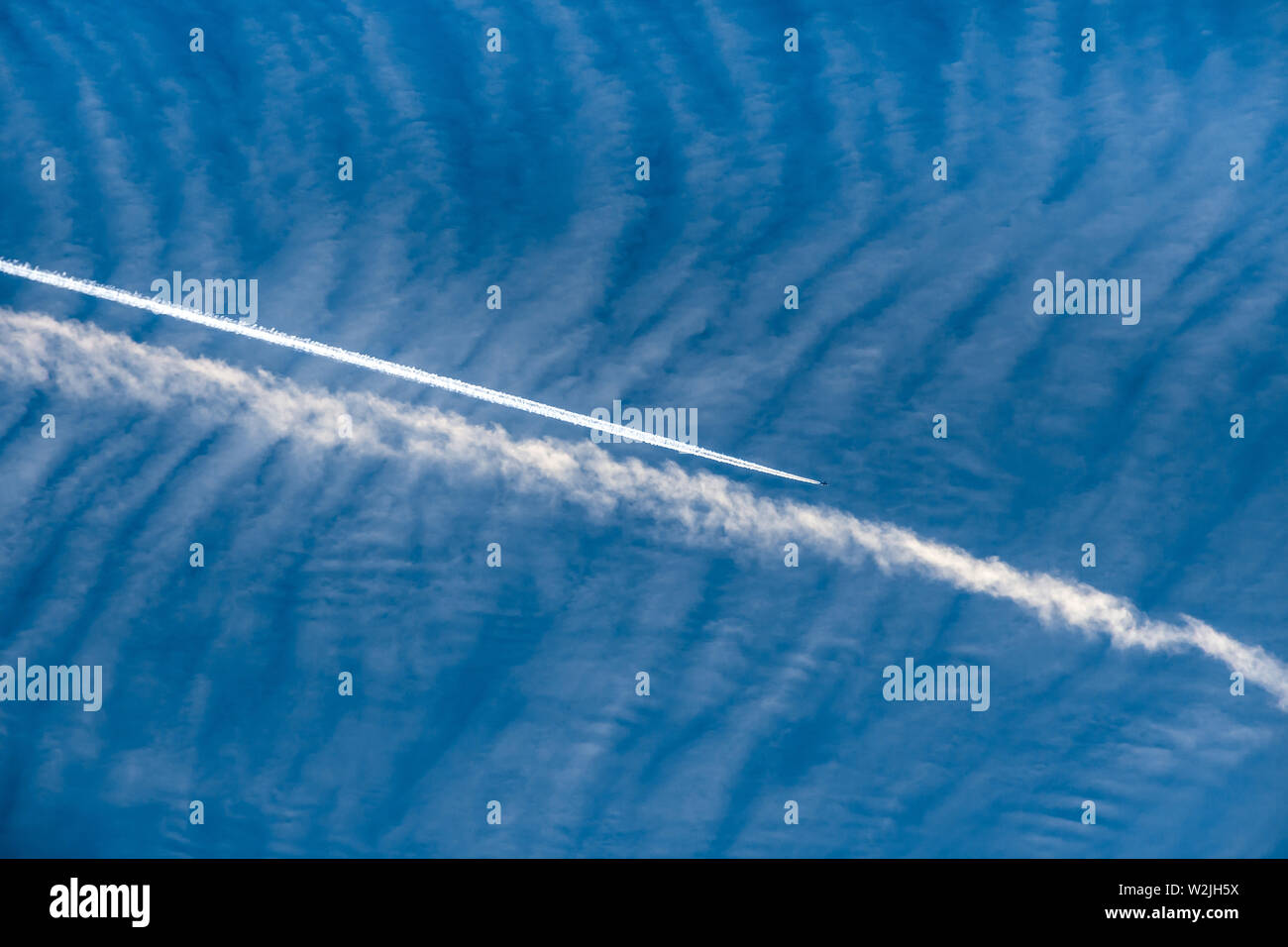 High Cirrus clouds and plane contrail - France Stock Photo - Alamy