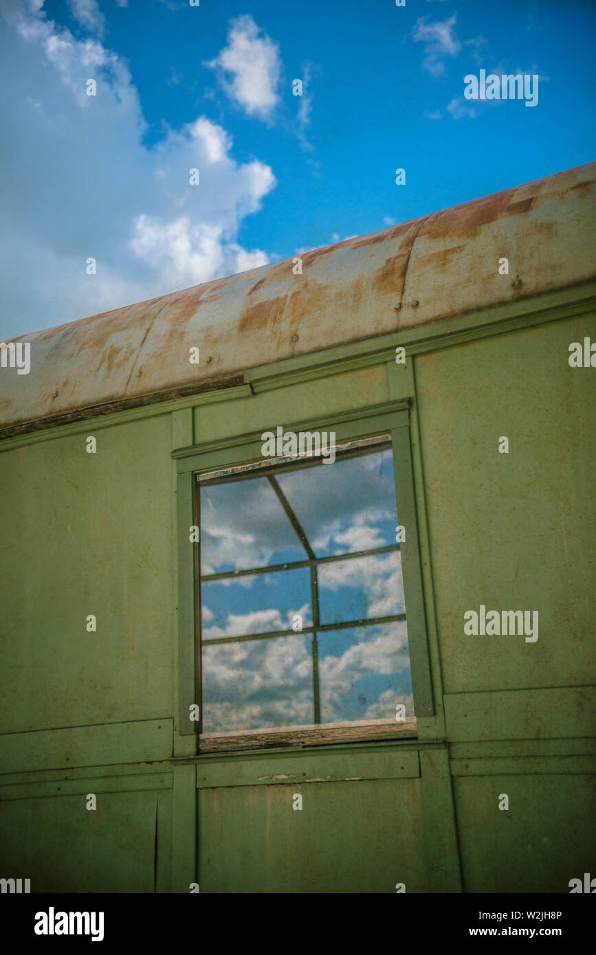 Reflection of sky and clouds in window of old train carriage Stock ...