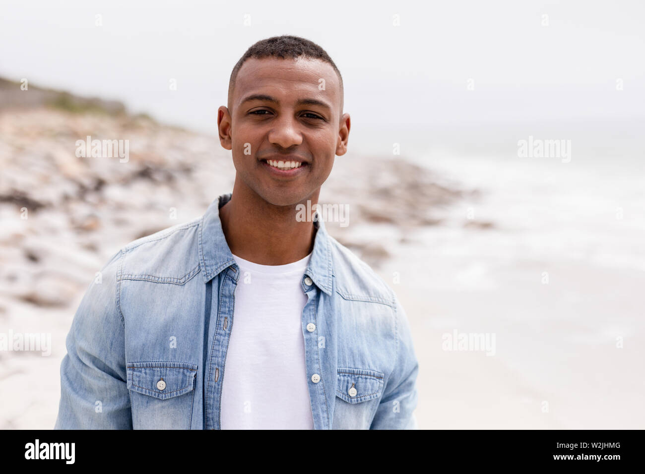 Happy man standing on the beach Stock Photo - Alamy