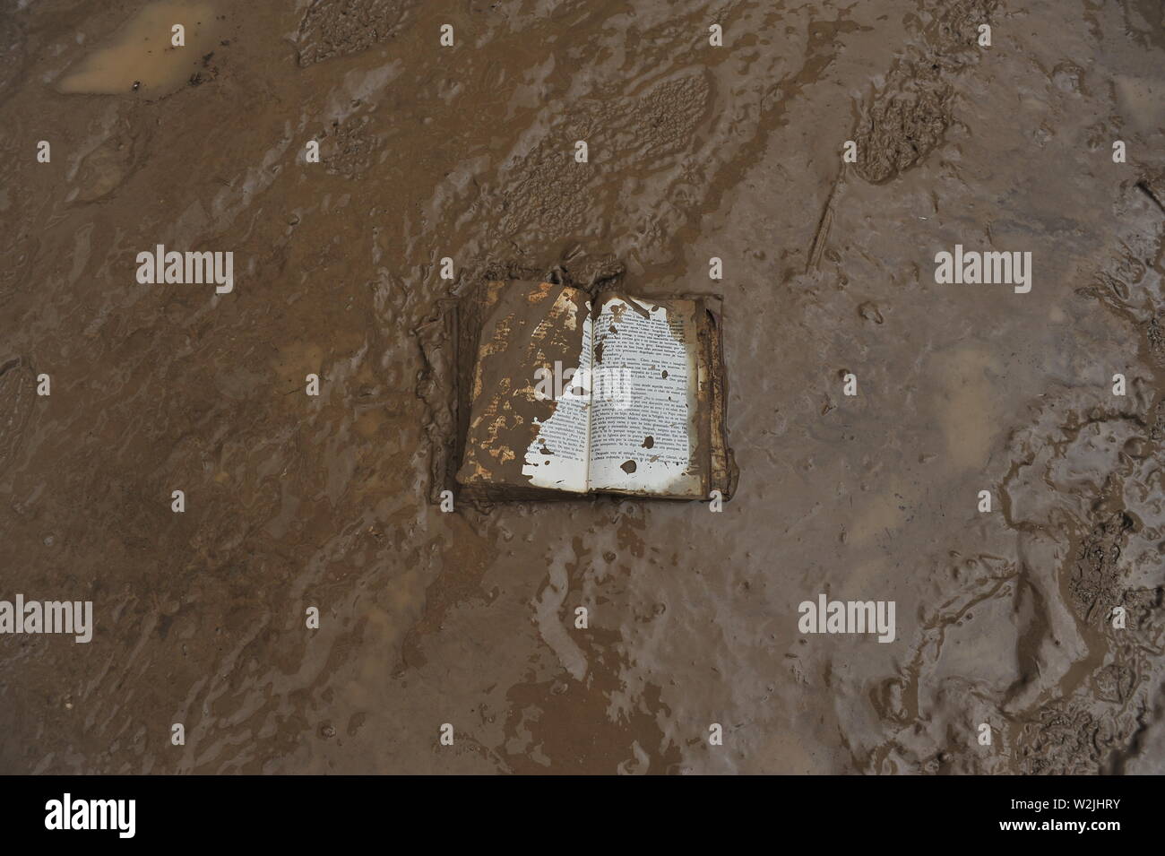 A book rests in the mud, after the disaster.Floods caused by the ...