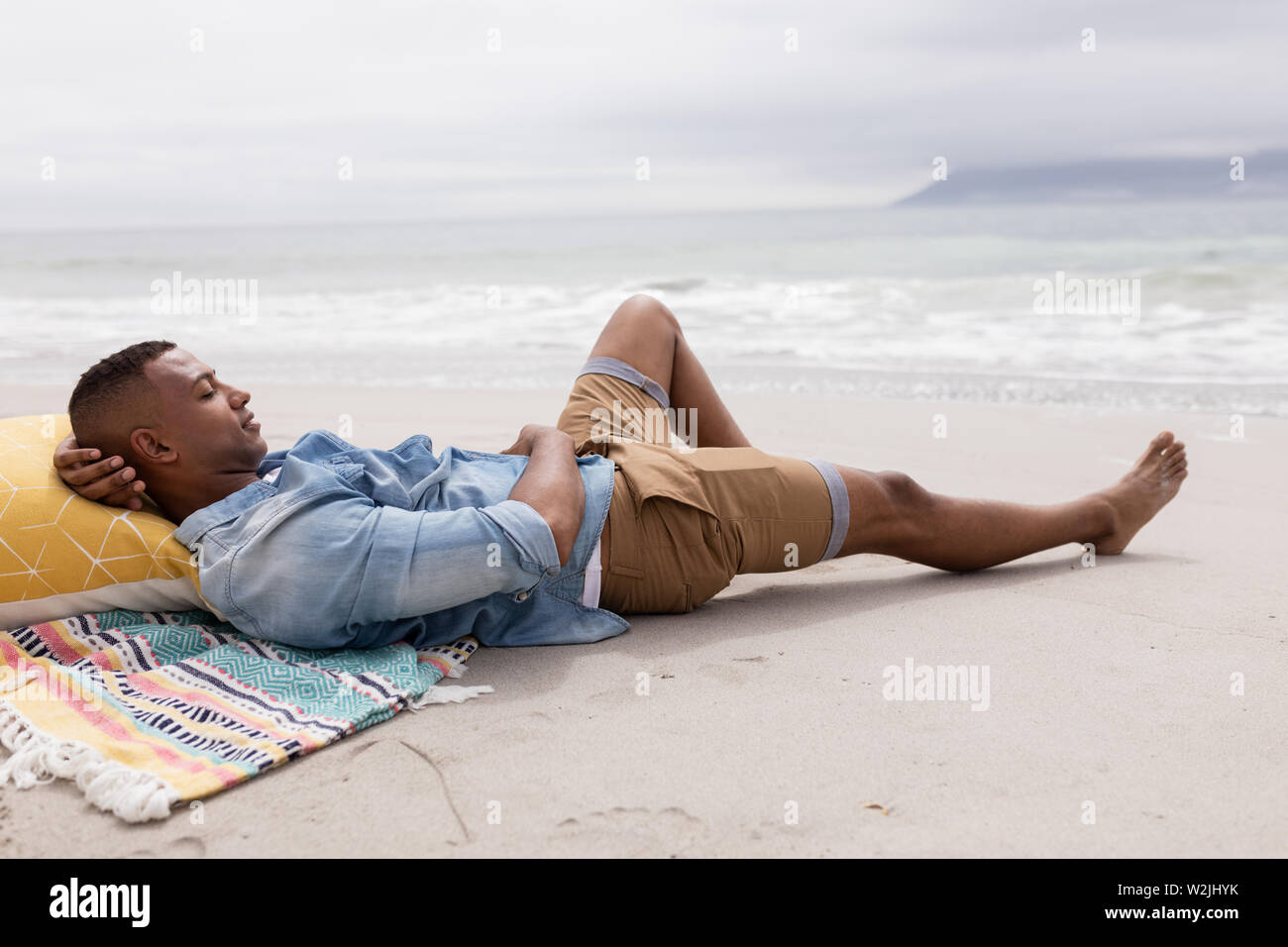 Man sleeping at beach on a sunny day Stock Photo - Alamy