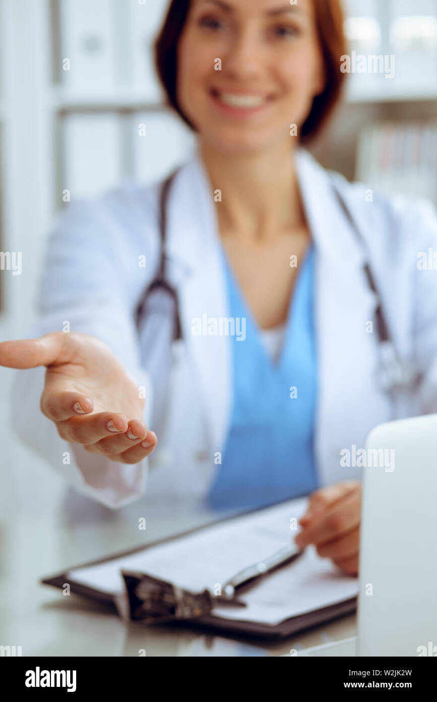 Closeup of medicine doctor offering helping hand or handshake ...