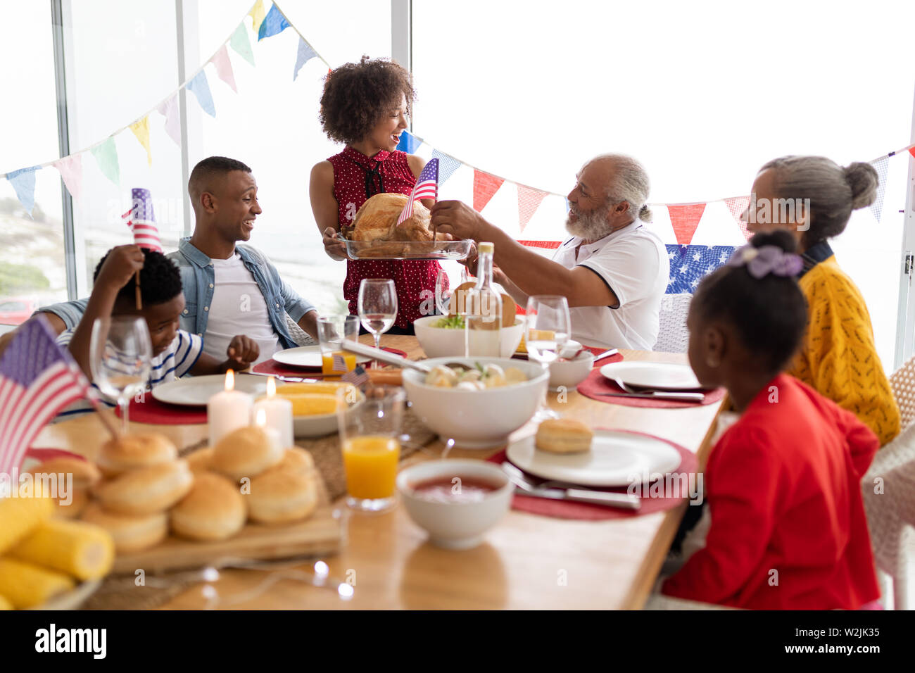Multi-generation family having food together on a dining table Stock ...
