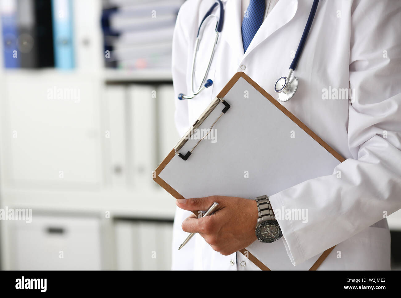 Doctor holding medical clipboard Stock Photo - Alamy
