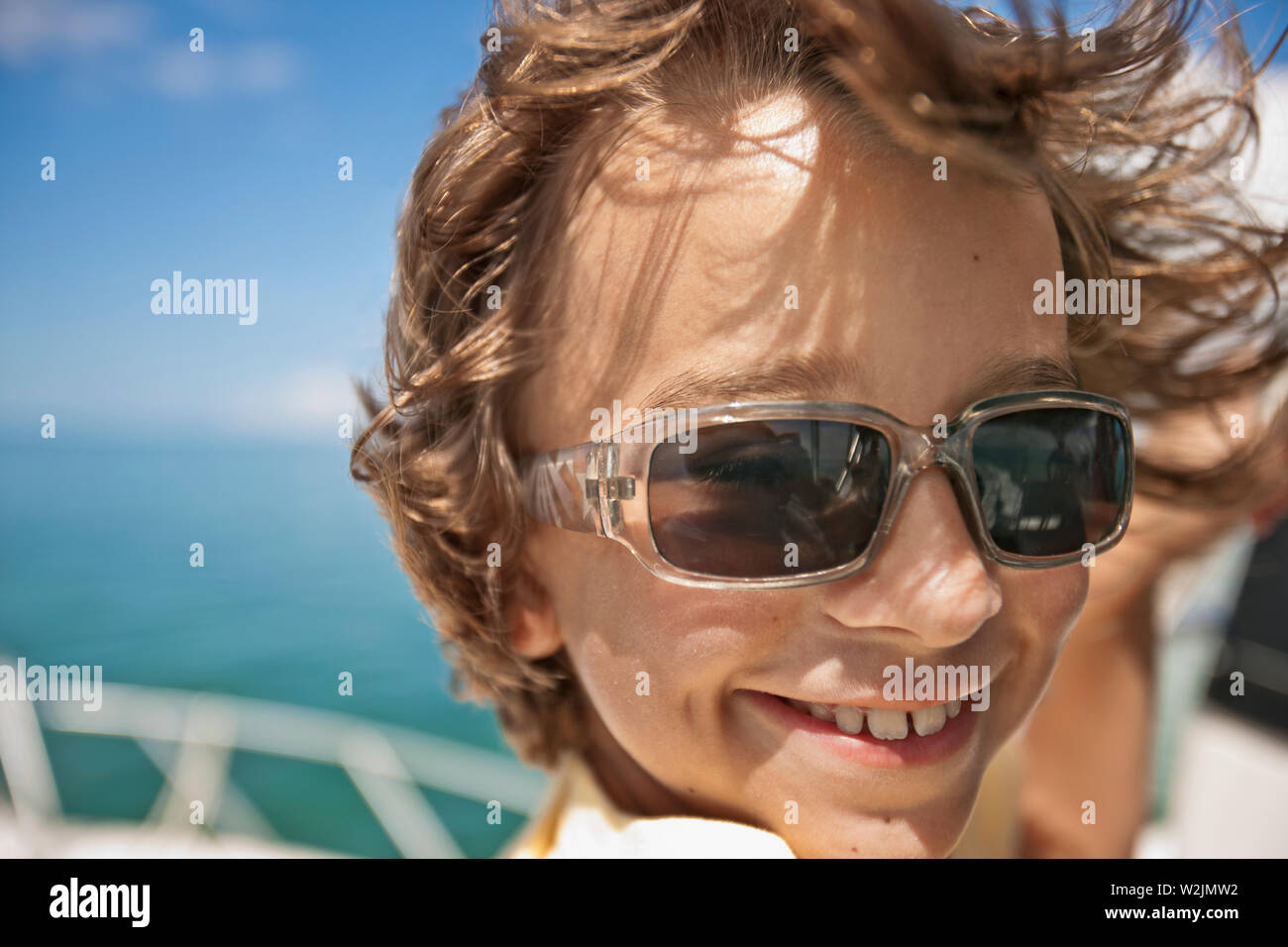 Portrait of a smiling young boy on a boat Stock Photo - Alamy