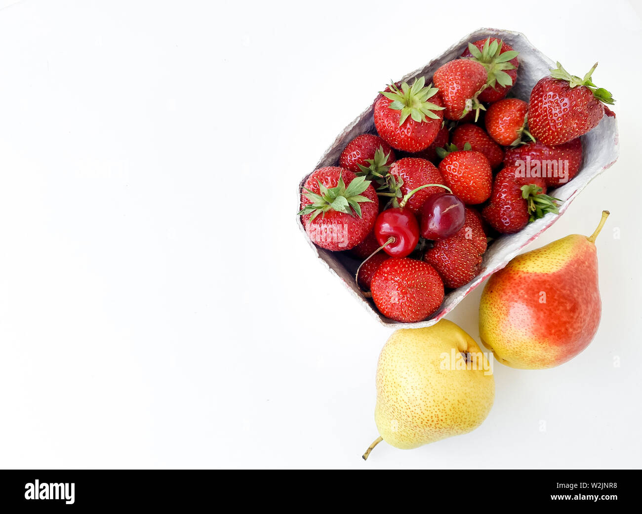 Fruit: isolated pears and strawberries in white background and place ...