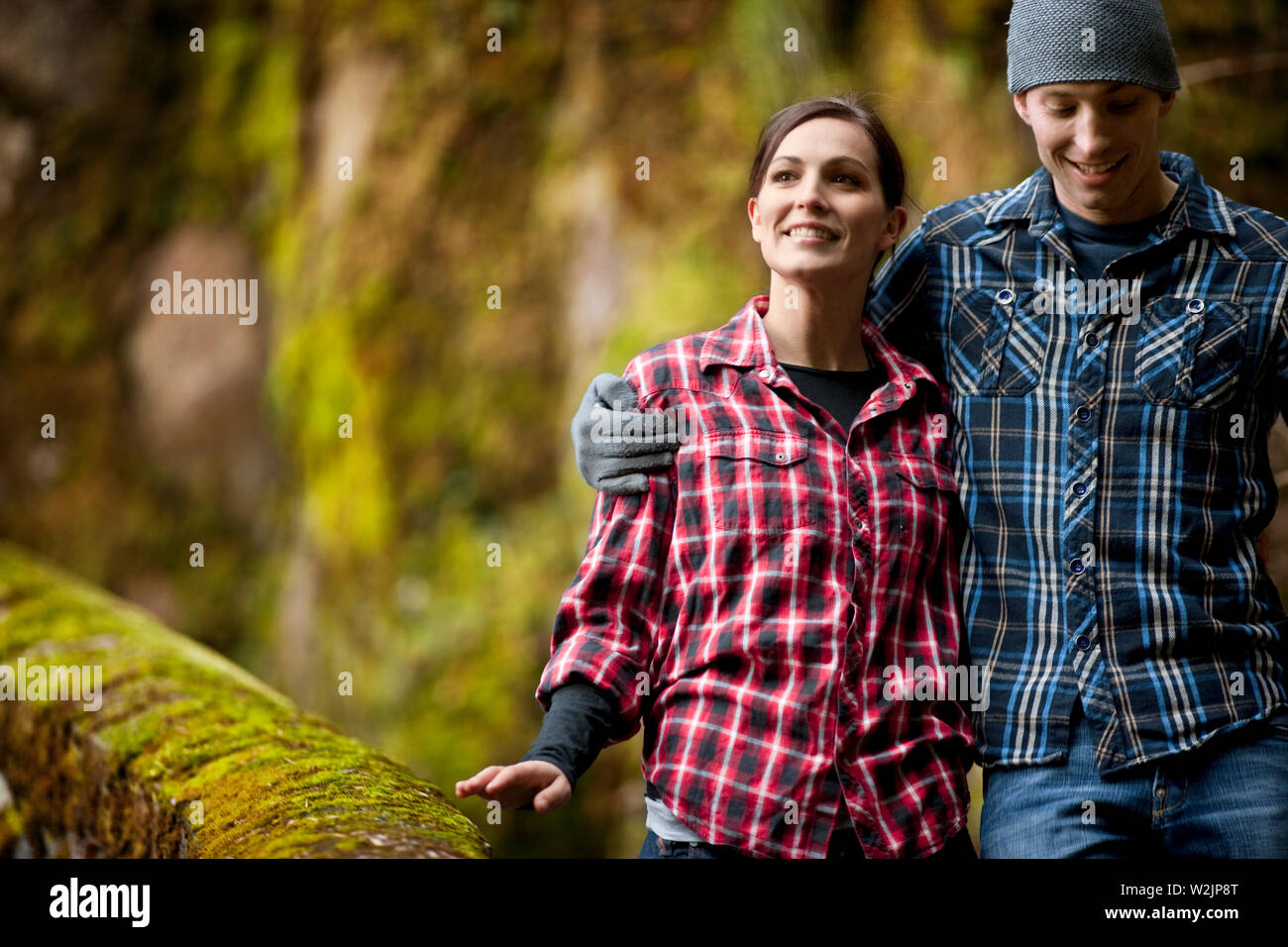 Young couple walking in forest Stock Photo - Alamy