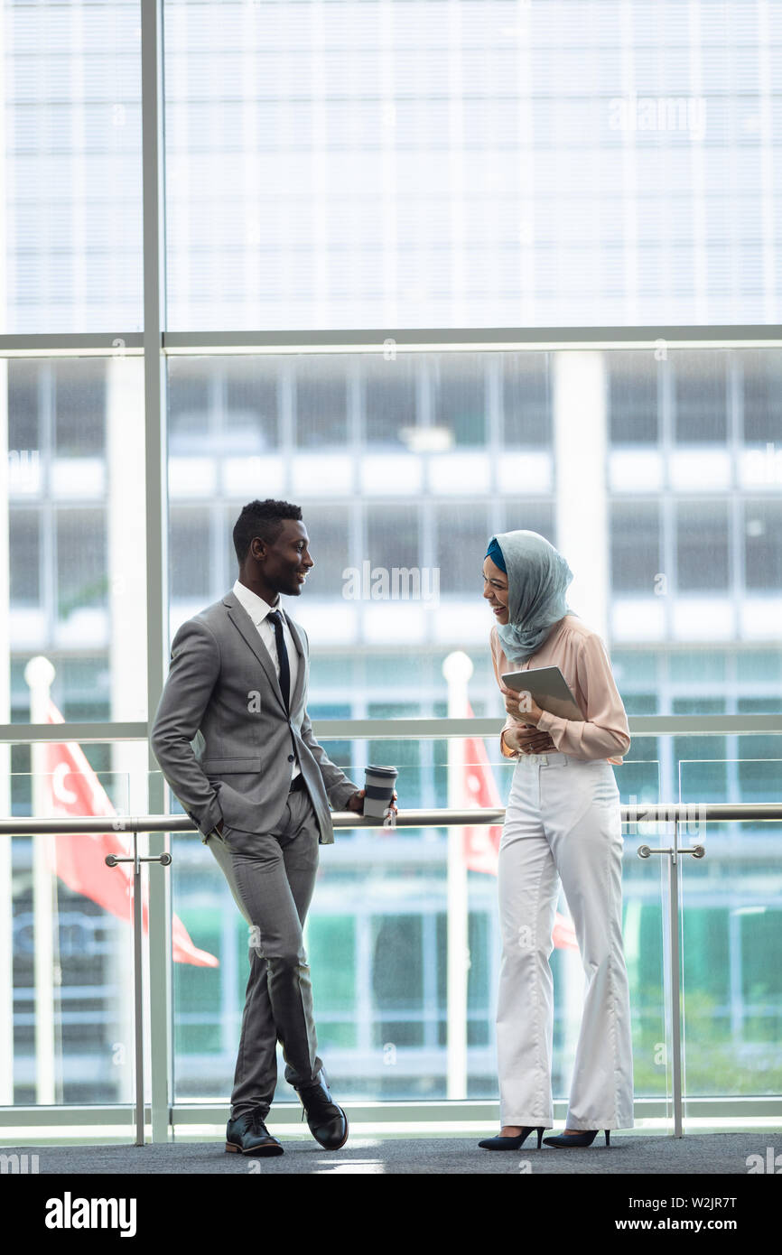 Diverse young executives laughing in modern office Stock Photo - Alamy