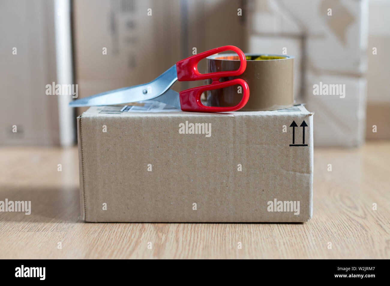 Shipping concept: Cardboard box, scissors and sticky tape Stock Photo ...