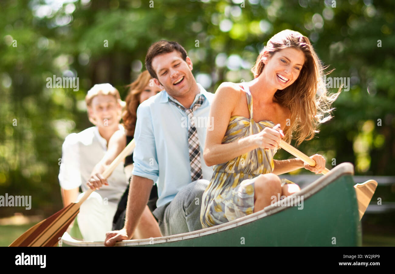 Four friends having fun while canoeing Stock Photo - Alamy