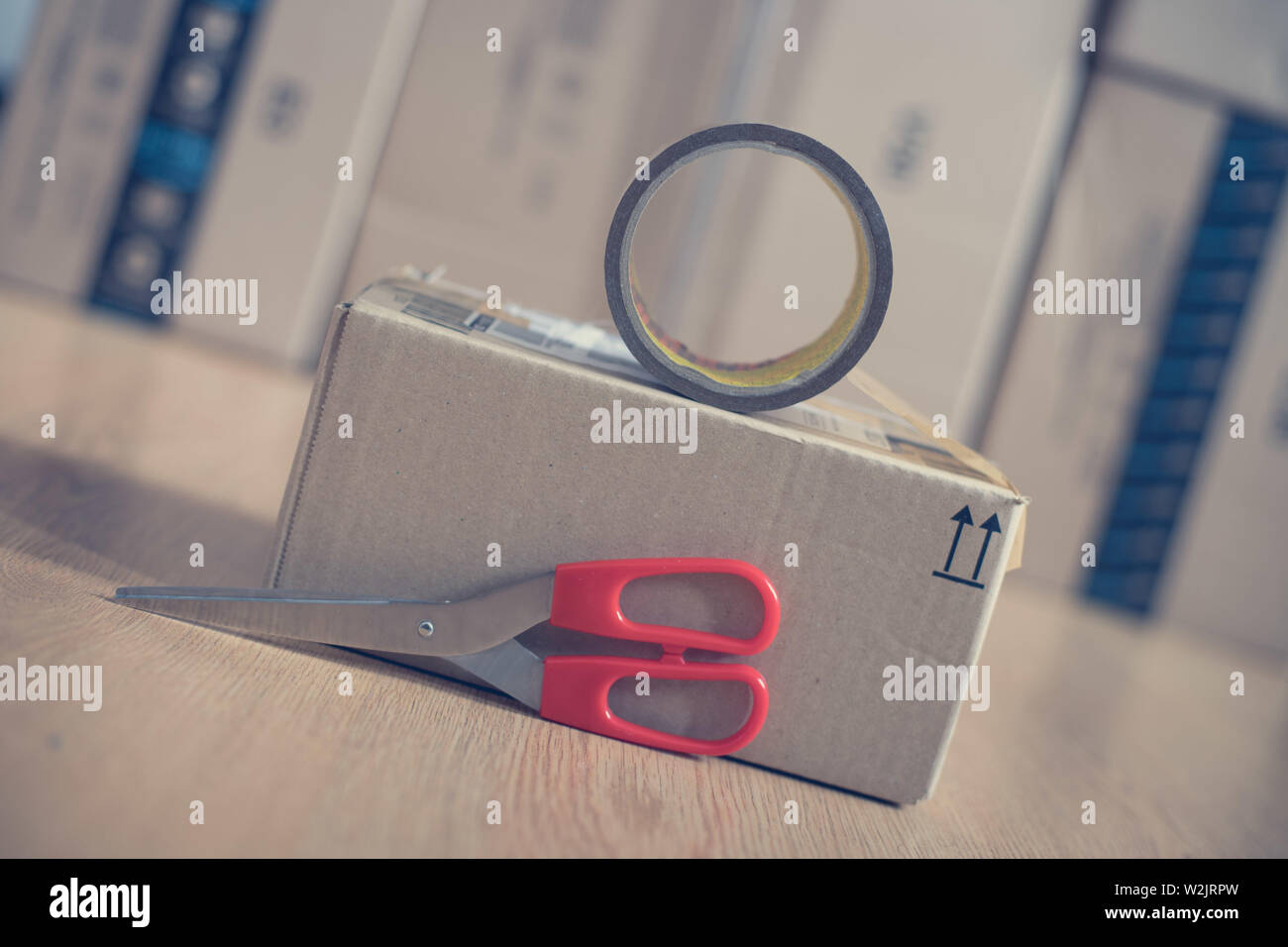 Shipping concept: Cardboard box, scissors and sticky tape Stock Photo ...