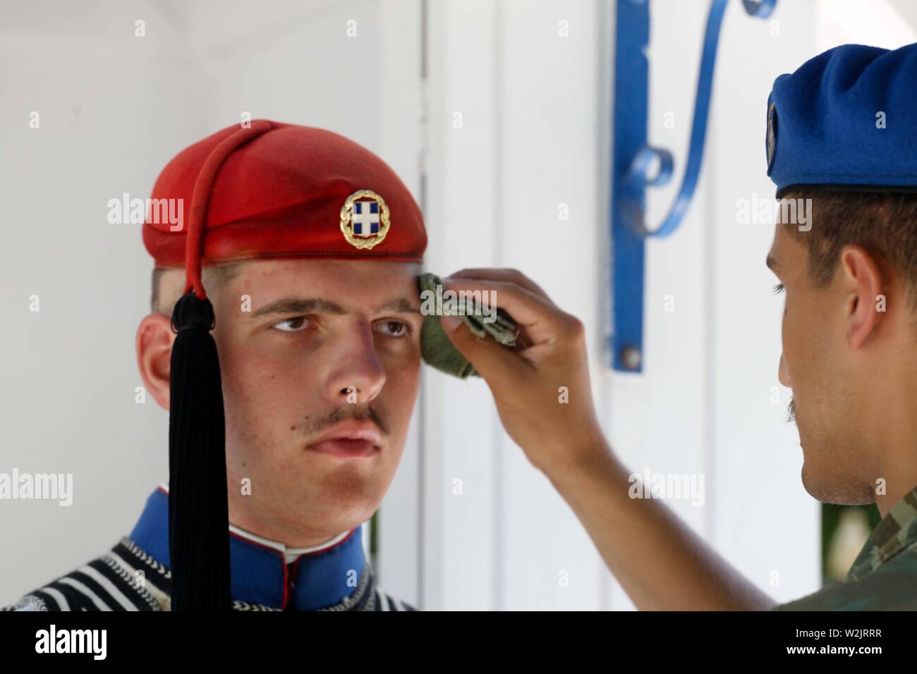 Athens, Greece. 9th July, 2019. Officer wipes the sweat from ...