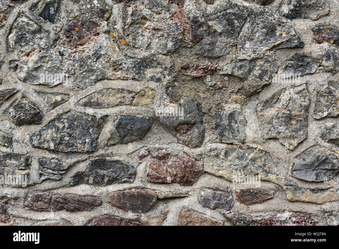 A stone wall of irregularly shaped stone Stock Photo - Alamy