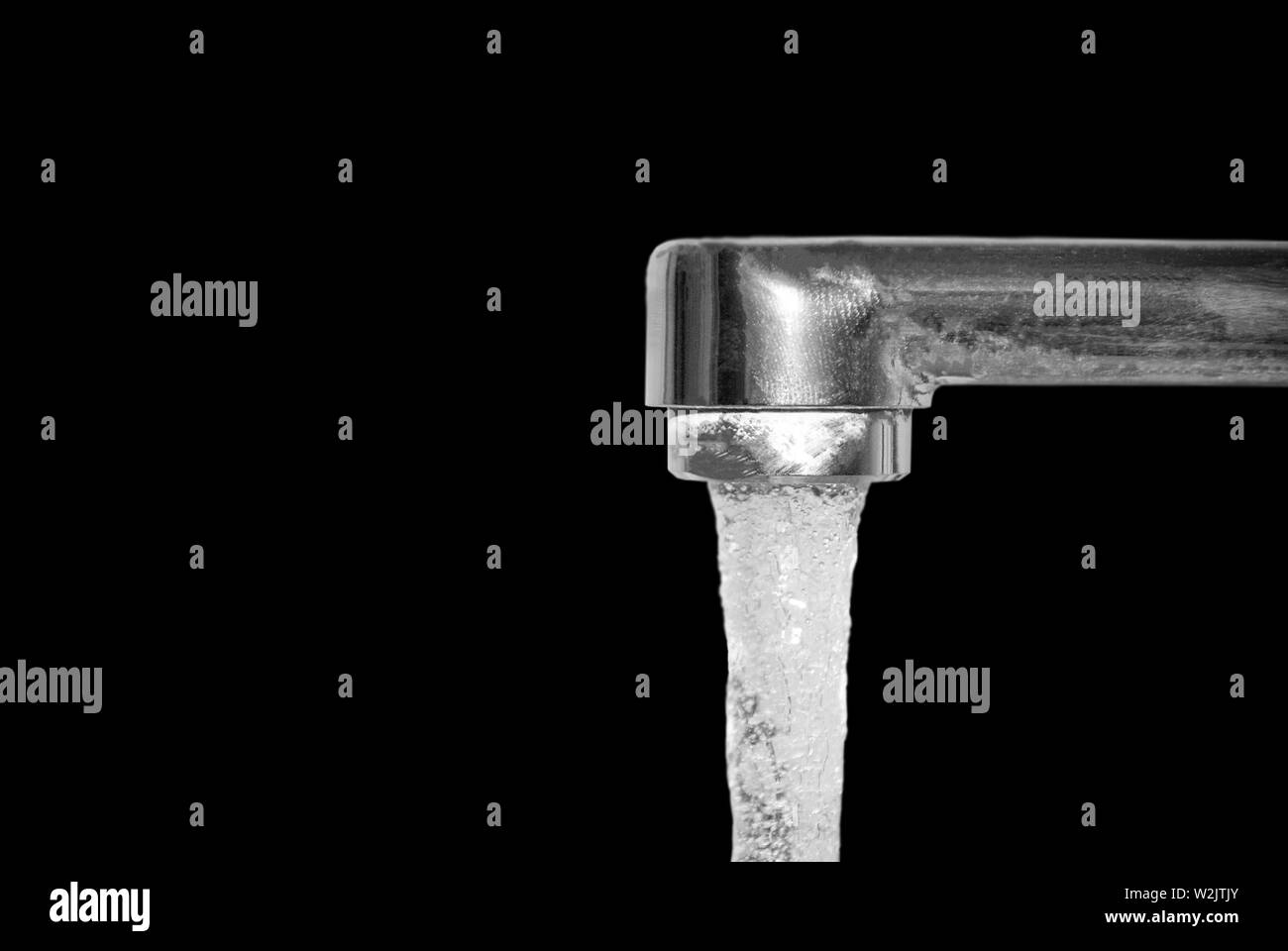 open water tap isolated on a black background Stock Photo - Alamy