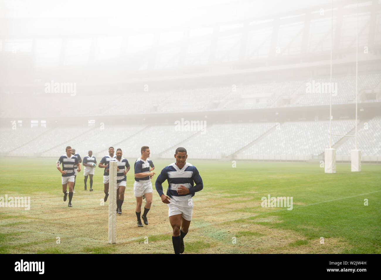 Group of diverse rugby players running together in stadium Stock Photo ...