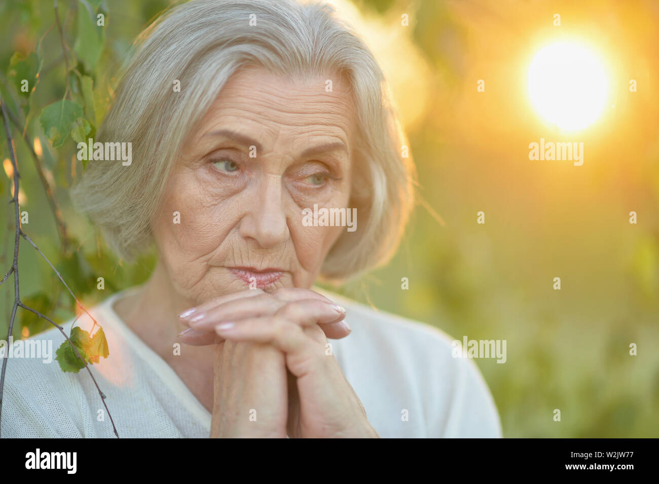 Portrait of sad senior beautiful woman posing in spring park Stock ...