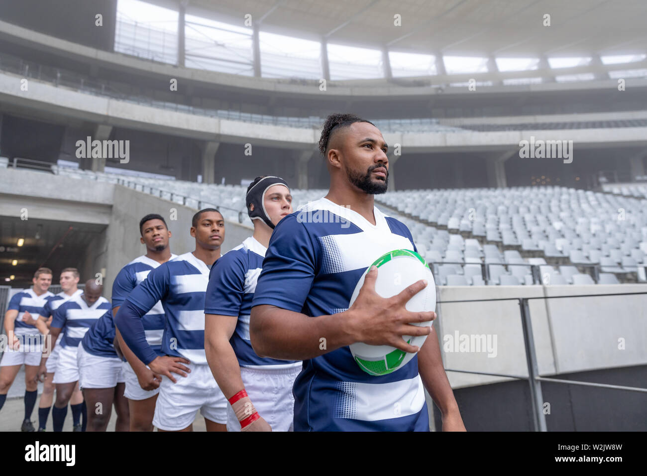 Group of Male rugby players entering stadium in a row for match Stock ...