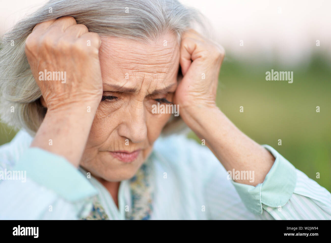 Portrait of senior beautiful woman with headache Stock Photo - Alamy