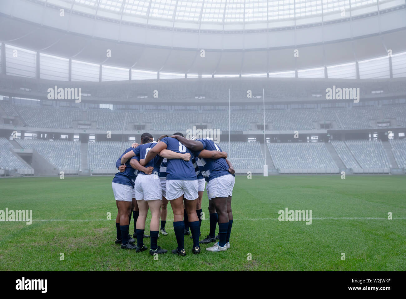 Group of male rugby players forming huddles in the morning Stock Photo ...