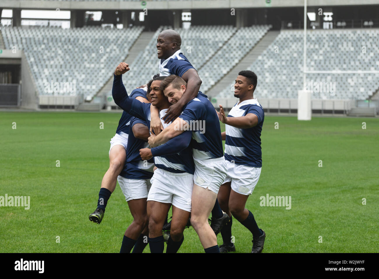Group of diverse Male rugby players celebrating goal in stadium Stock ...