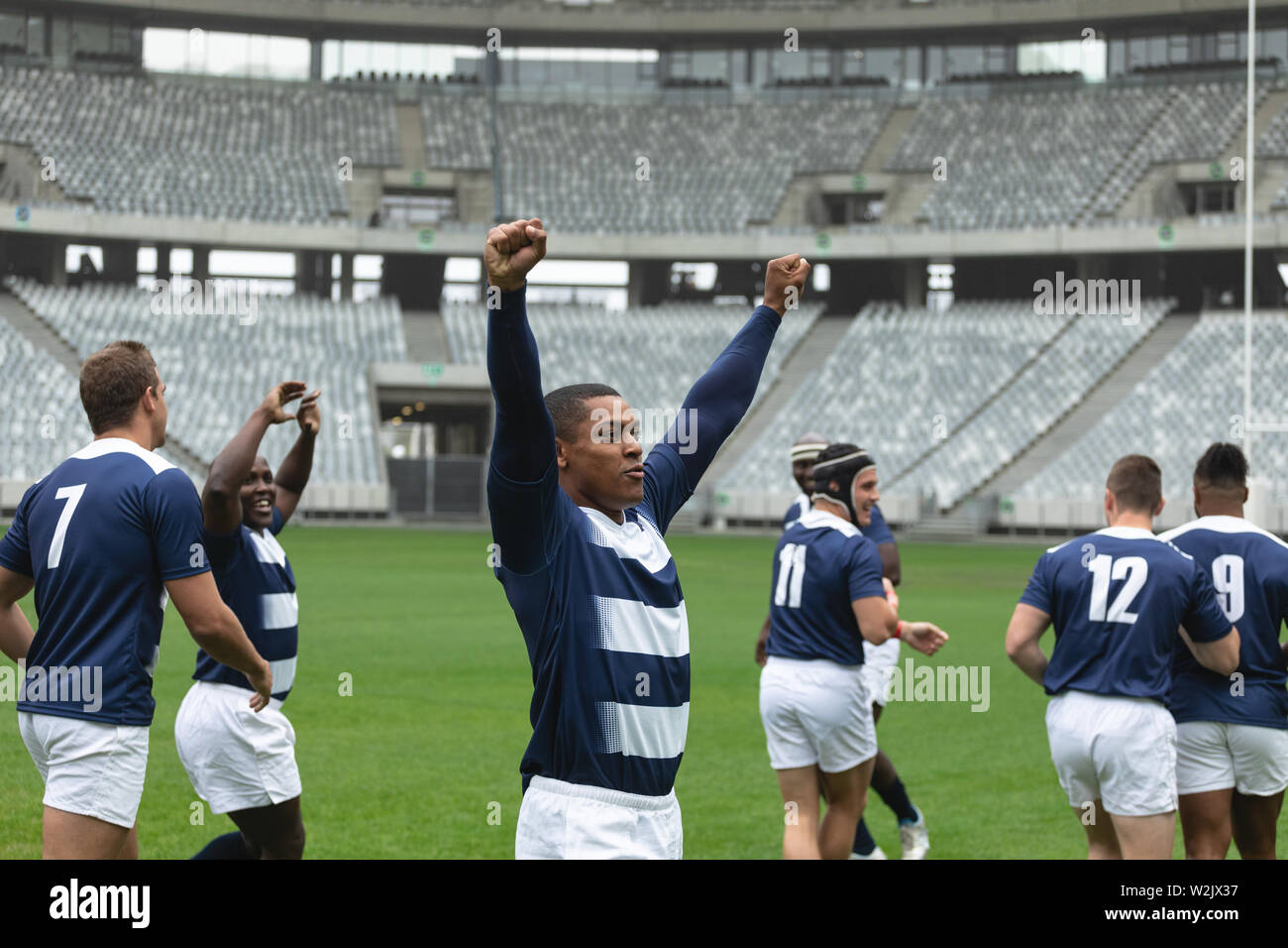 Diverse male rugby players celebrating goal in stadium Stock Photo - Alamy