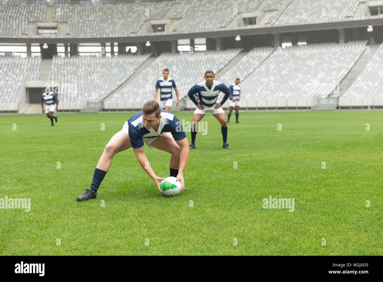 Diverse male rugby players playing rugby match in stadium Stock Photo ...