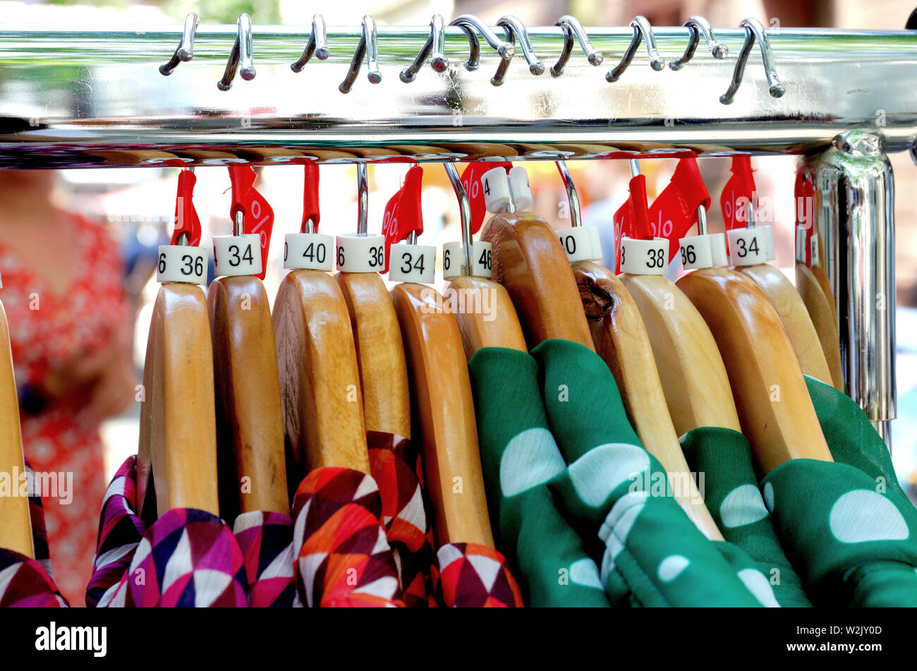 clothes on hangers at a street market Stock Photo - Alamy