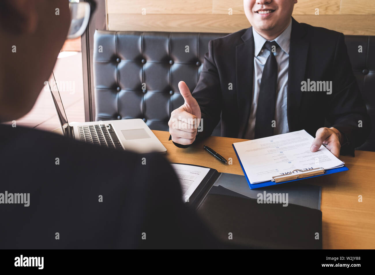 Employer or recruiter holding reading a resume during about his profile ...