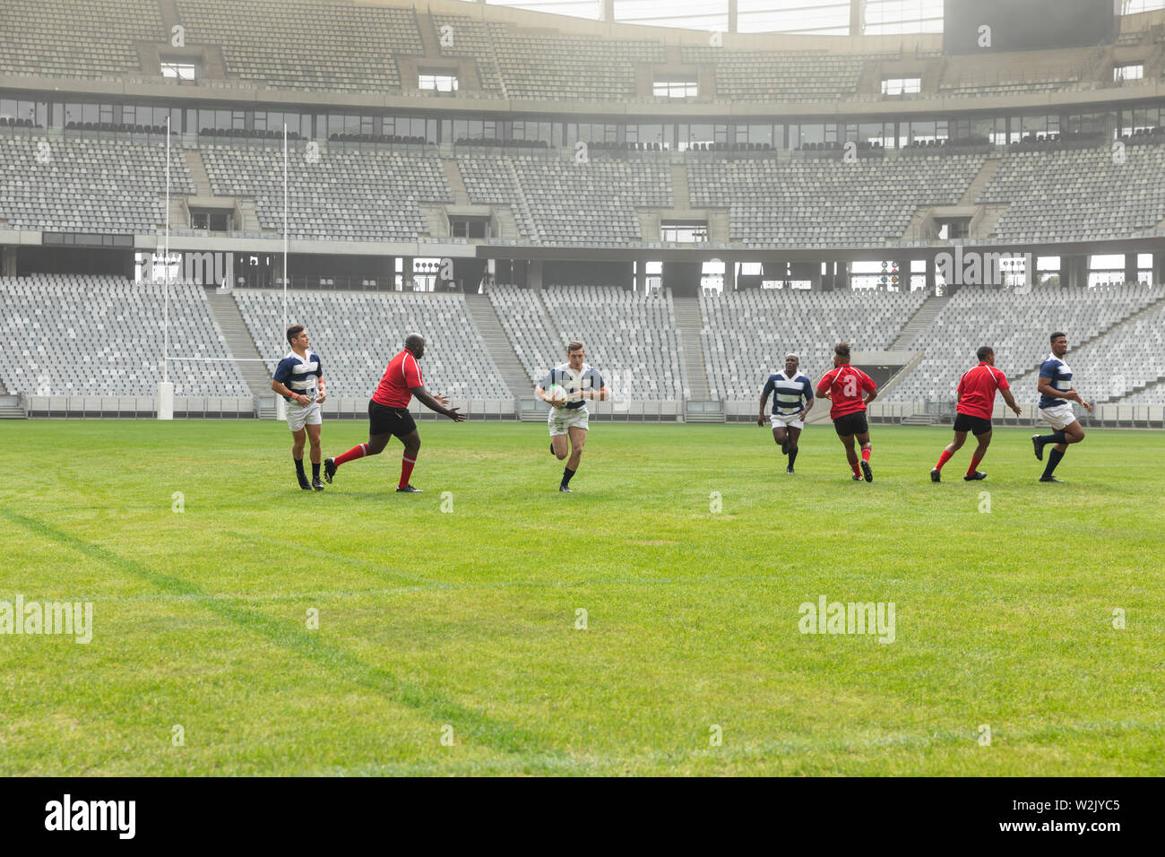 Group of diverse male rugby players playing rugby in stadium Stock ...