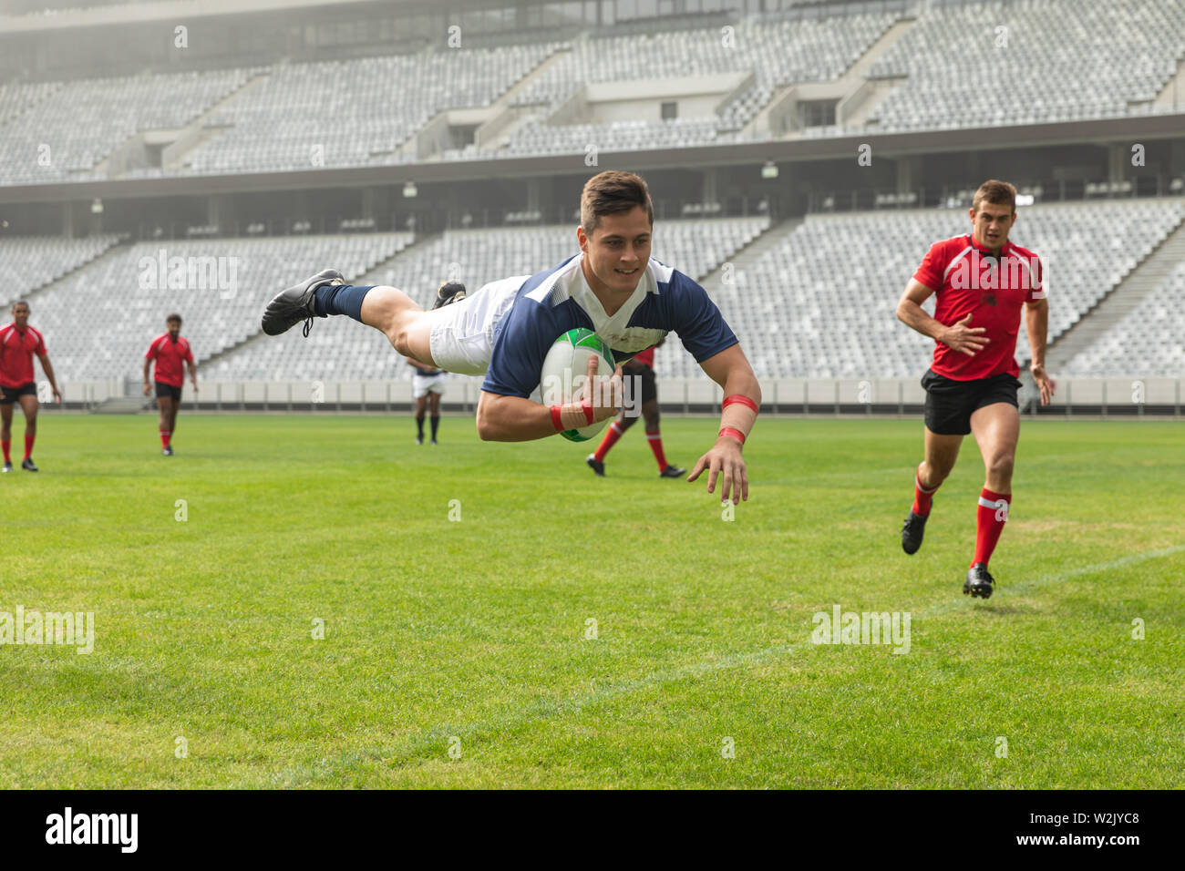 Group of diverse male rugby players playing rugby in stadium Stock ...