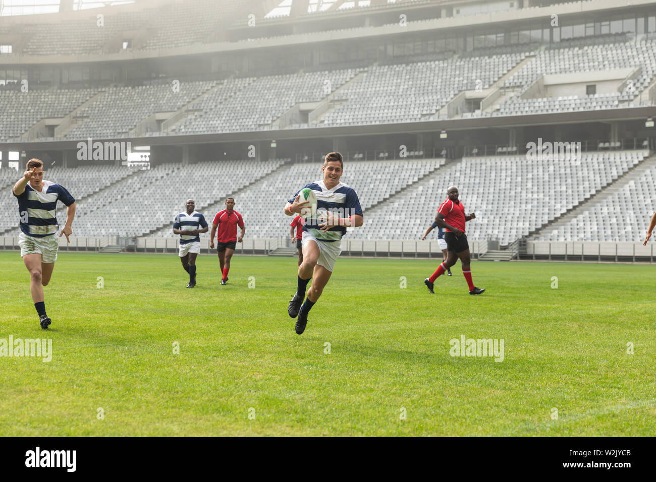 Group of diverse male rugby players playing rugby in stadium Stock ...