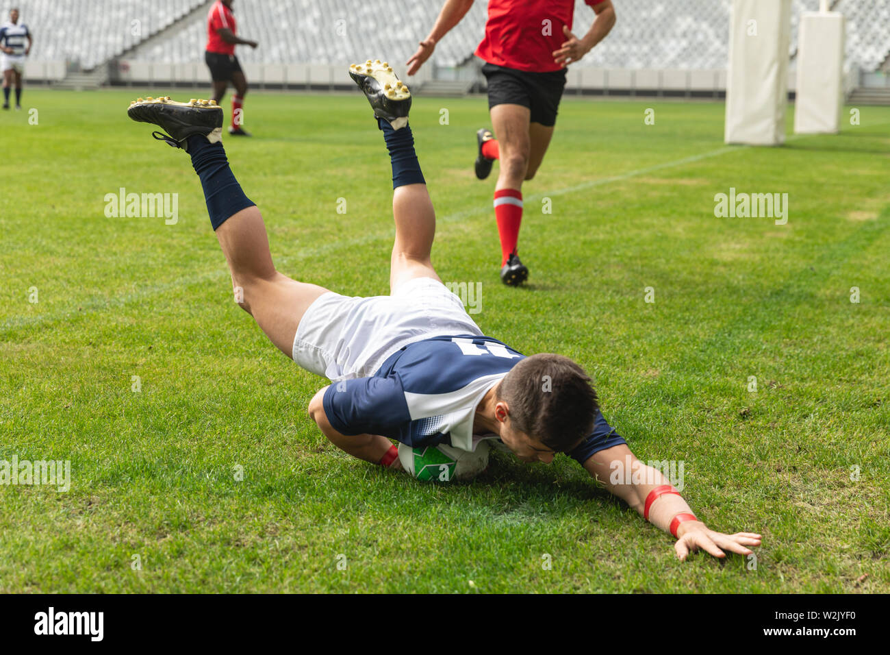 Group of diverse male rugby players playing rugby in stadium Stock ...