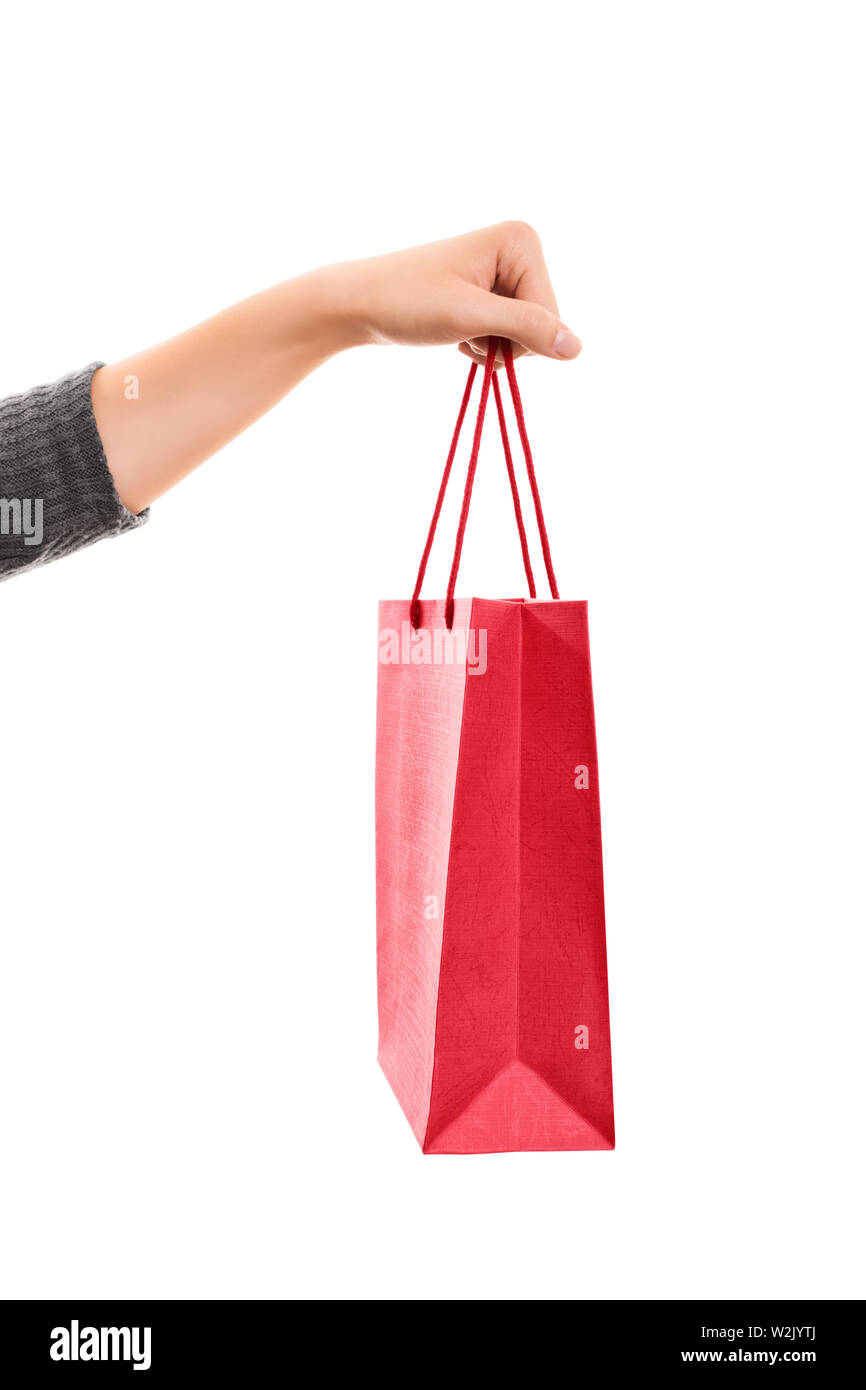 A close up shot of a female hand holding a shopping bag, isolated on ...