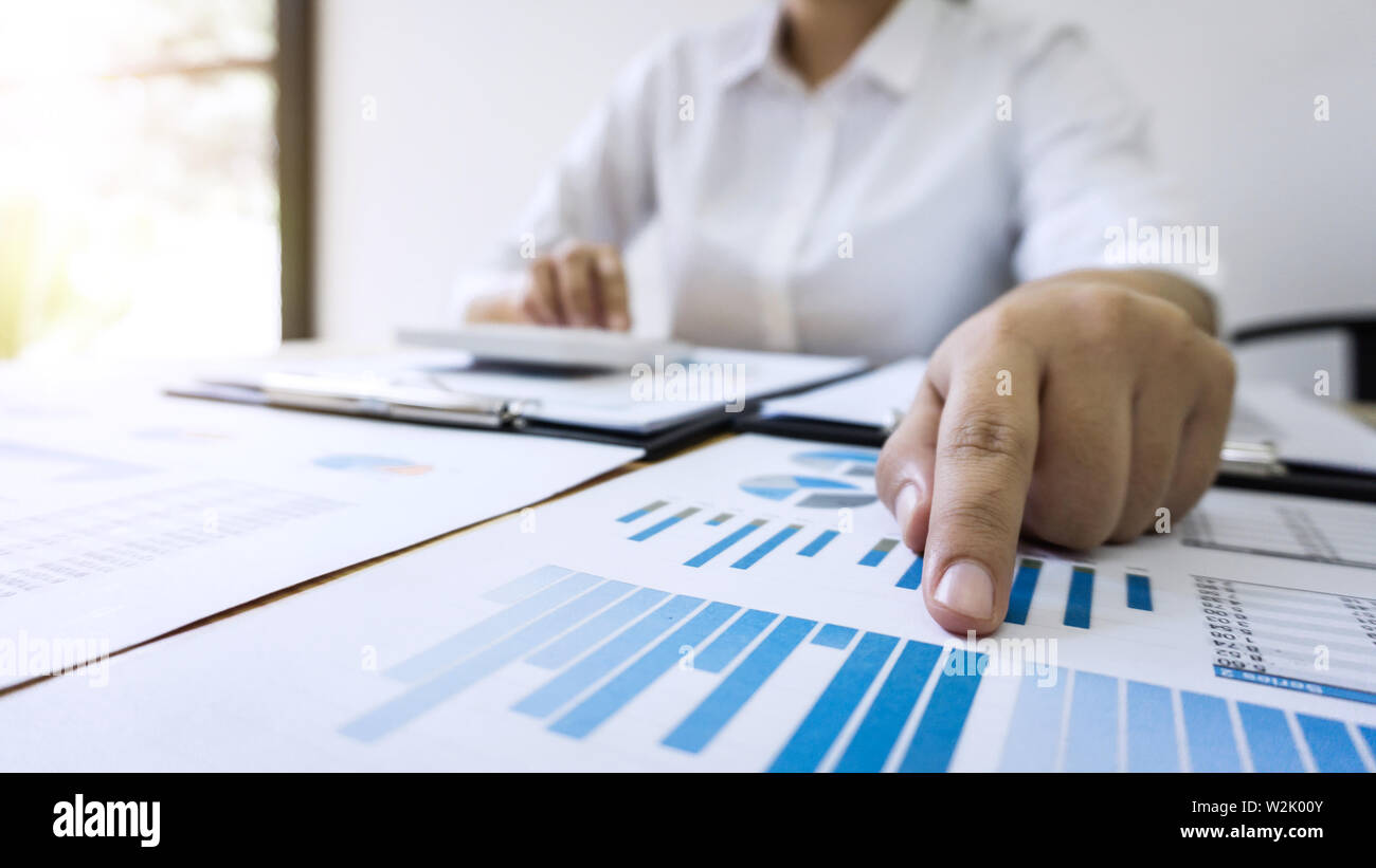 Business woman accountant working and calculating financial data on ...