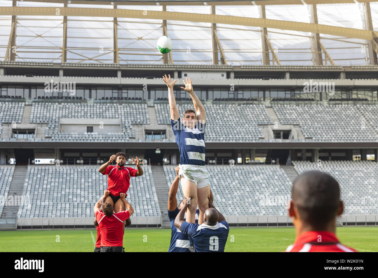 Male rugby players playing rugby match in stadium Stock Photo - Alamy