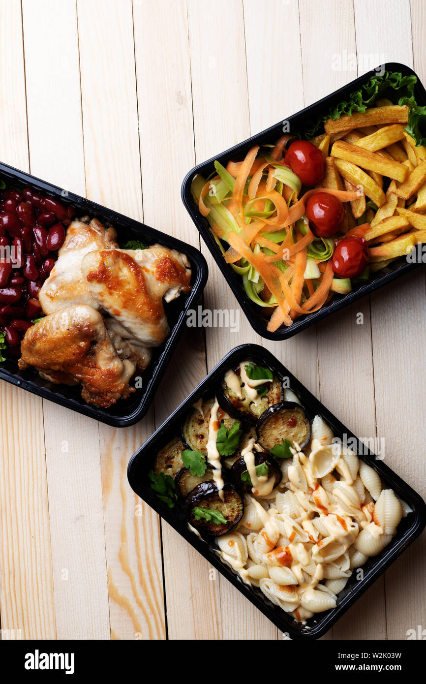 closeup of main course, lunch in food boxes, roast chicken wings ...