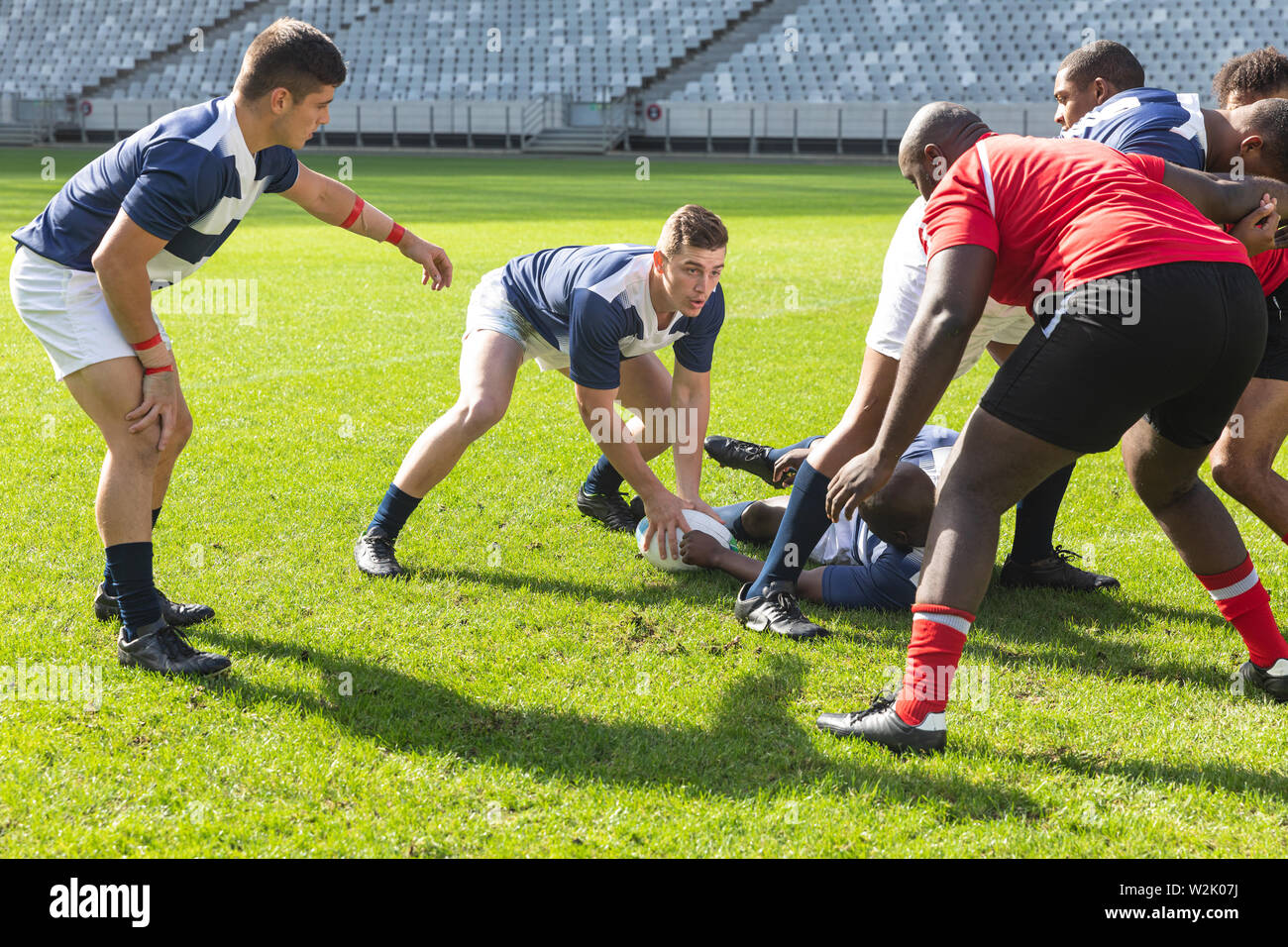 Male rugby players playing rugby match in stadium Stock Photo - Alamy