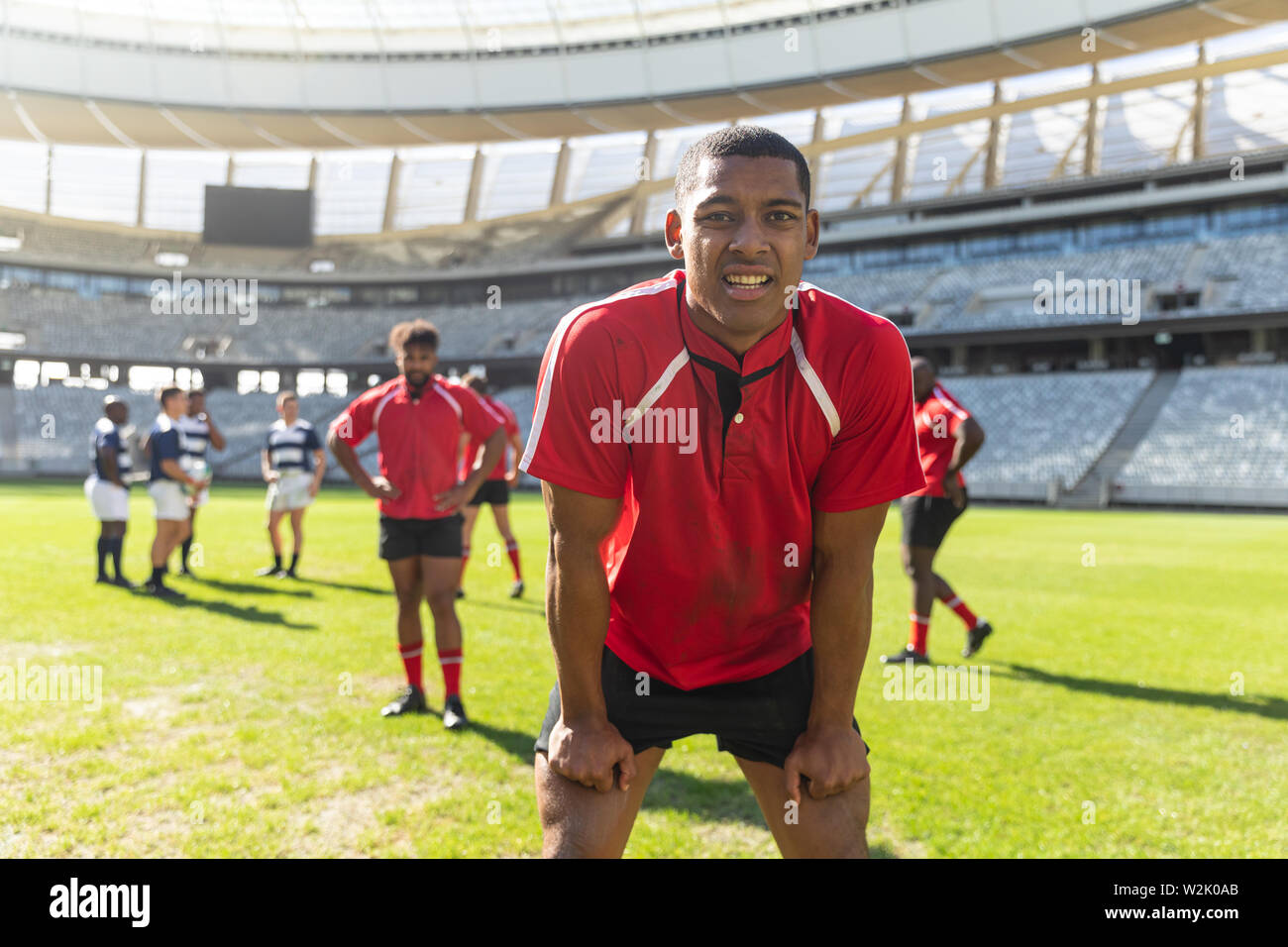 Tired male rugby player standing in stadium Stock Photo - Alamy