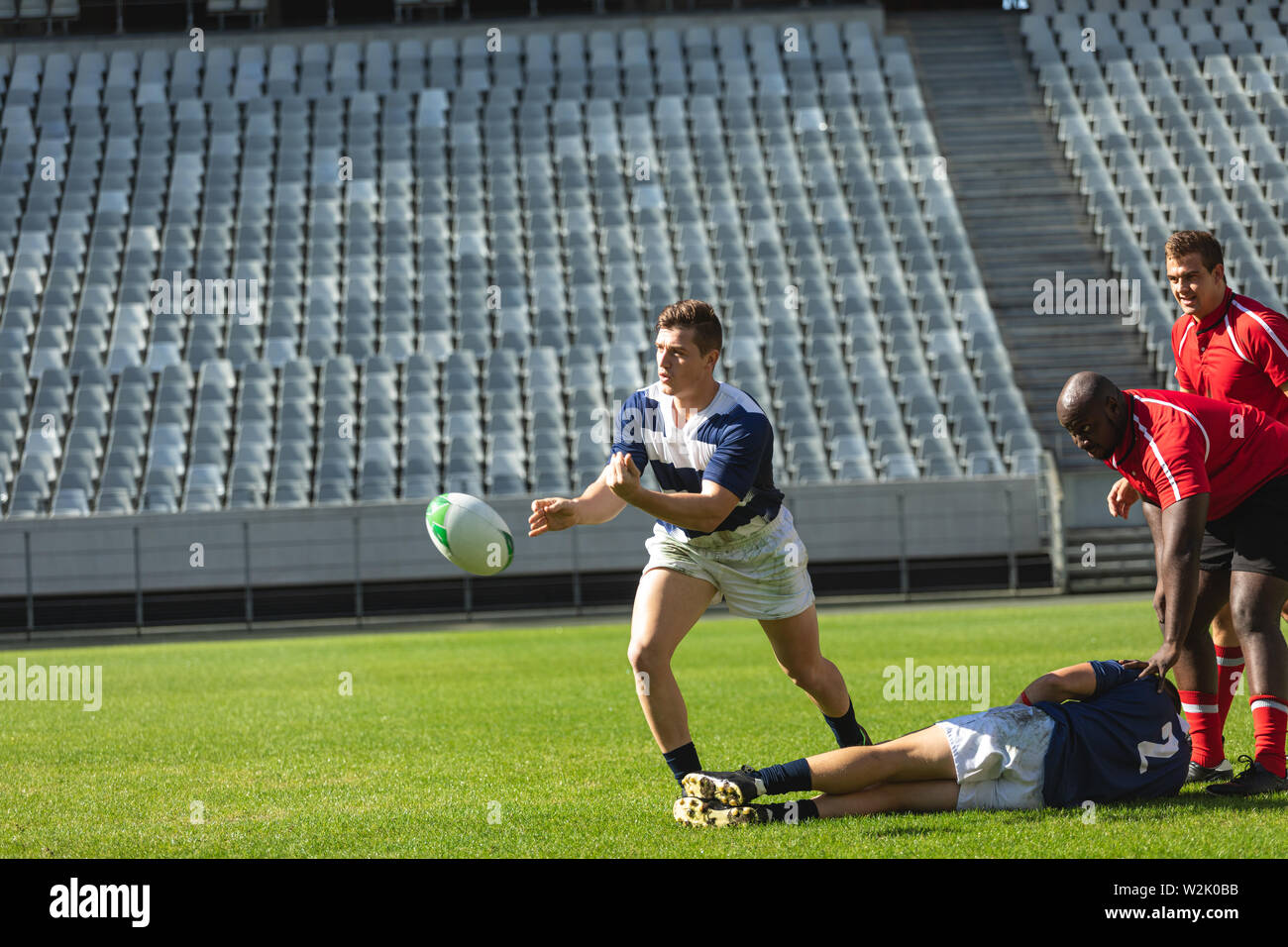 Male rugby players playing rugby match in stadium Stock Photo - Alamy