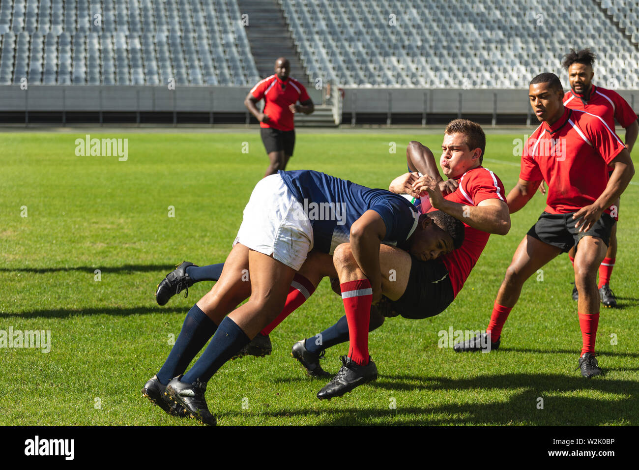 Male rugby players playing rugby match in stadium Stock Photo - Alamy