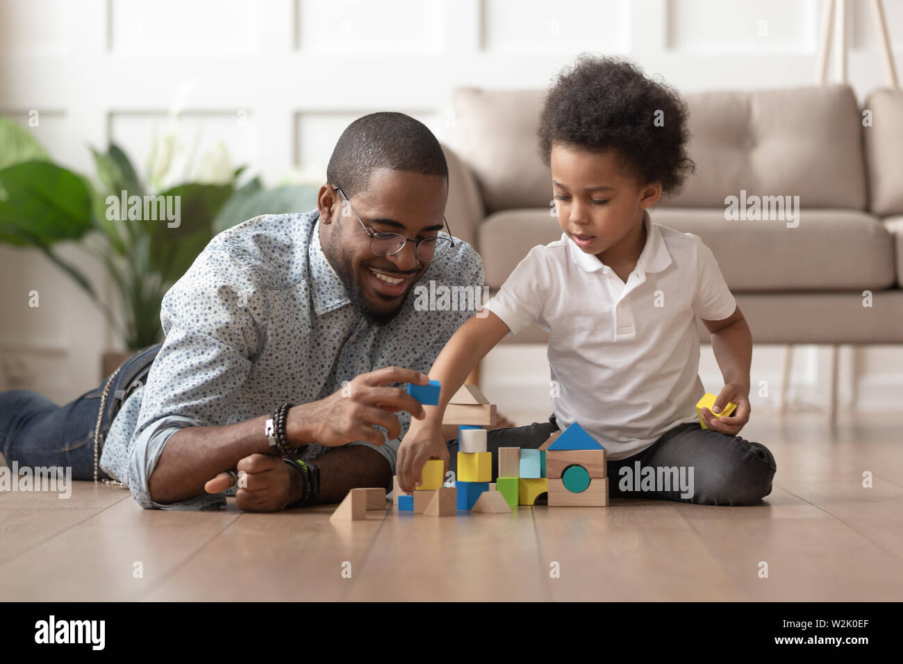 Happy african dad and child son building constructor from blocks Stock ...