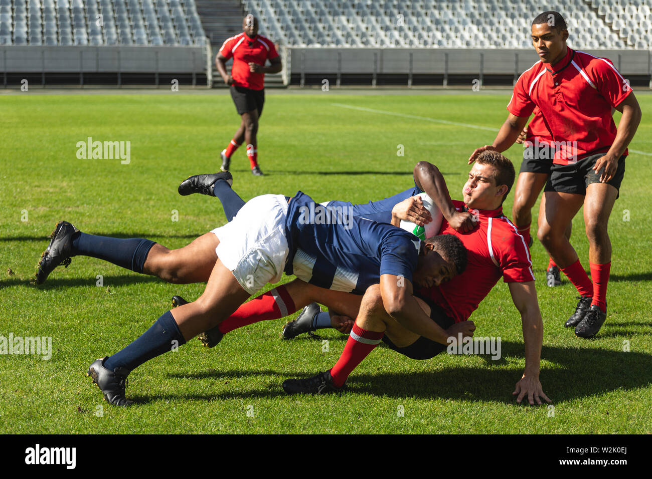 Male rugby players playing rugby match in stadium Stock Photo - Alamy
