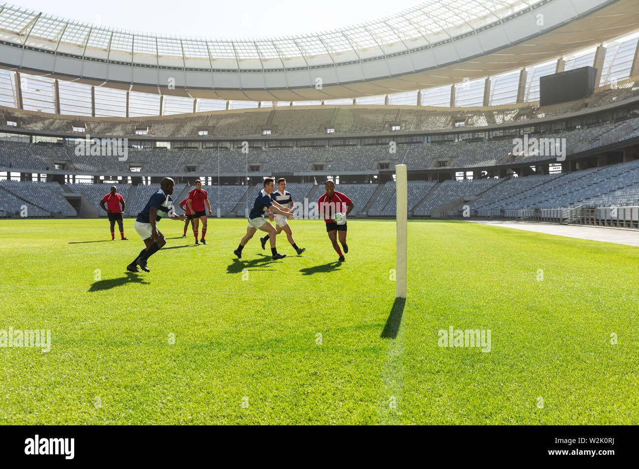 Male rugby players playing rugby match in stadium Stock Photo - Alamy