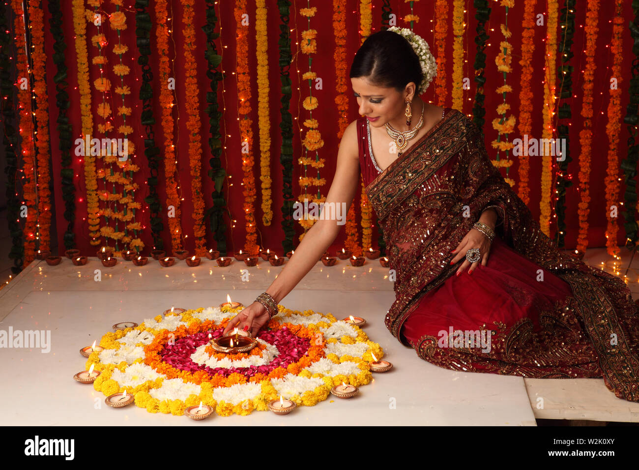 Woman making rangoli at Diwali Stock Photo - Alamy
