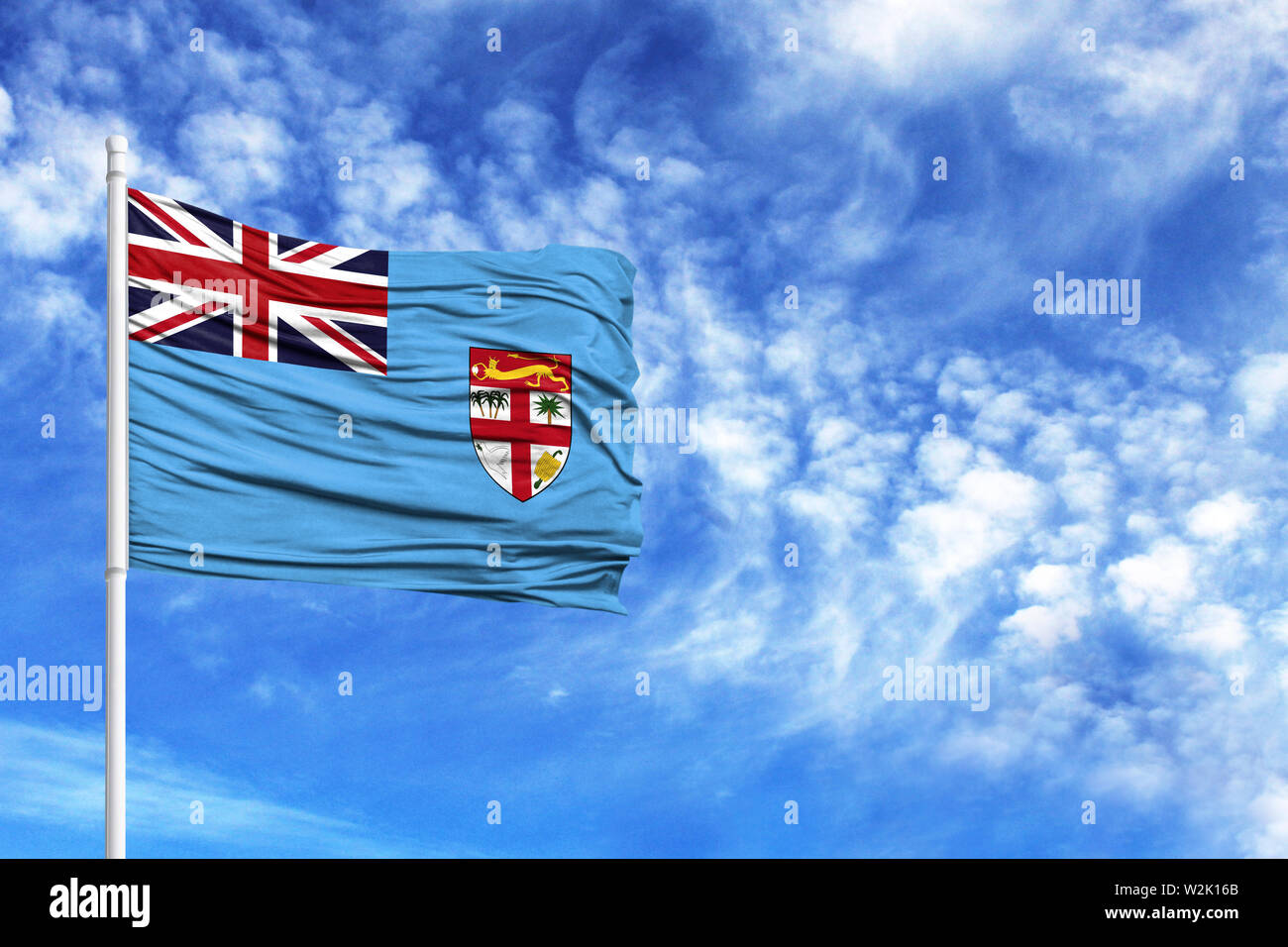 National flag of Fiji on a flagpole in front of blue sky Stock Photo ...