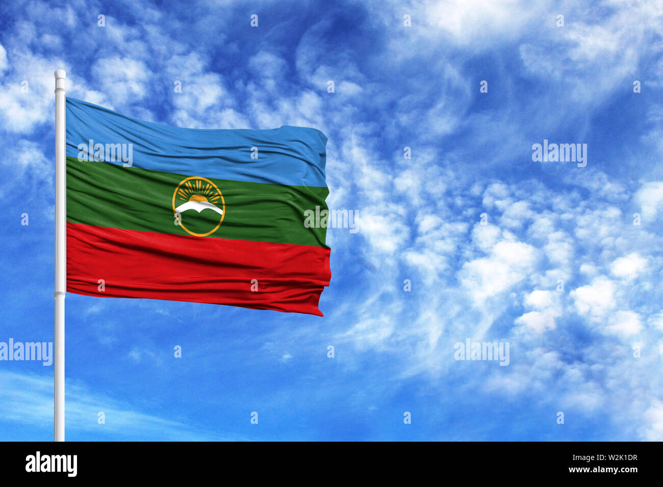 National flag of Karachay Cherkessia on a flagpole in front of blue sky ...